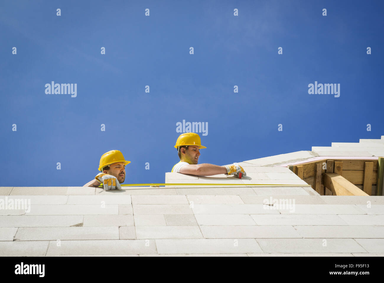 Builders are working on the top of house construction Stock Photo - Alamy