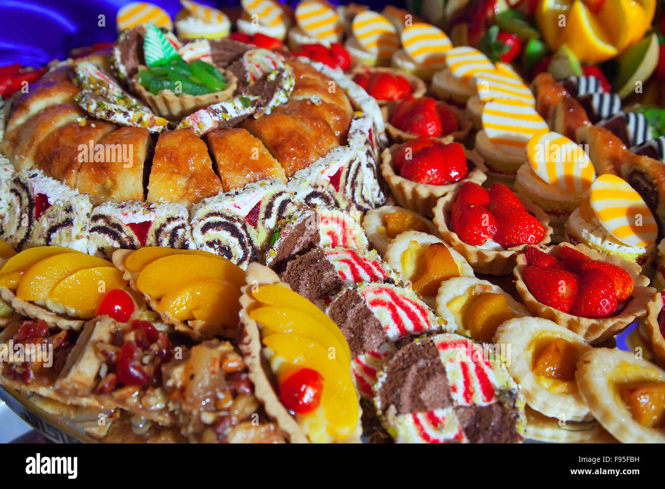 Different fresh cakes on banquet table Stock Photo - Alamy