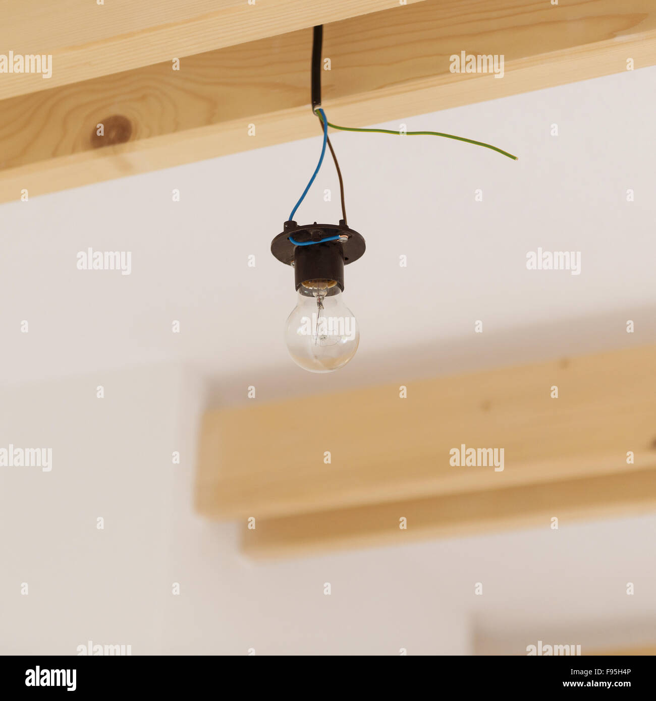 Hanging transparent glass bulb from unfinished construction Stock Photo ...