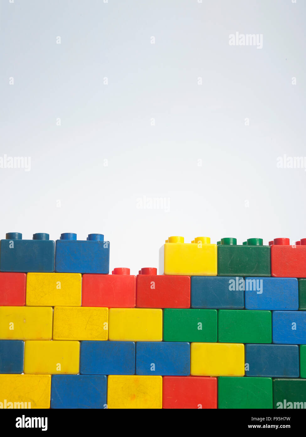 hand stack up lego set as a wall on white background Stock Photo - Alamy