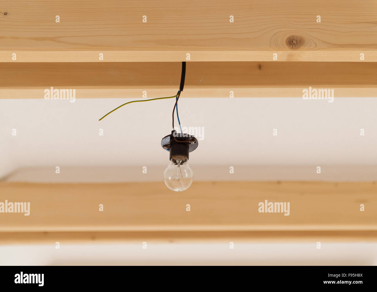Hanging transparent glass bulb from unfinished construction Stock Photo ...