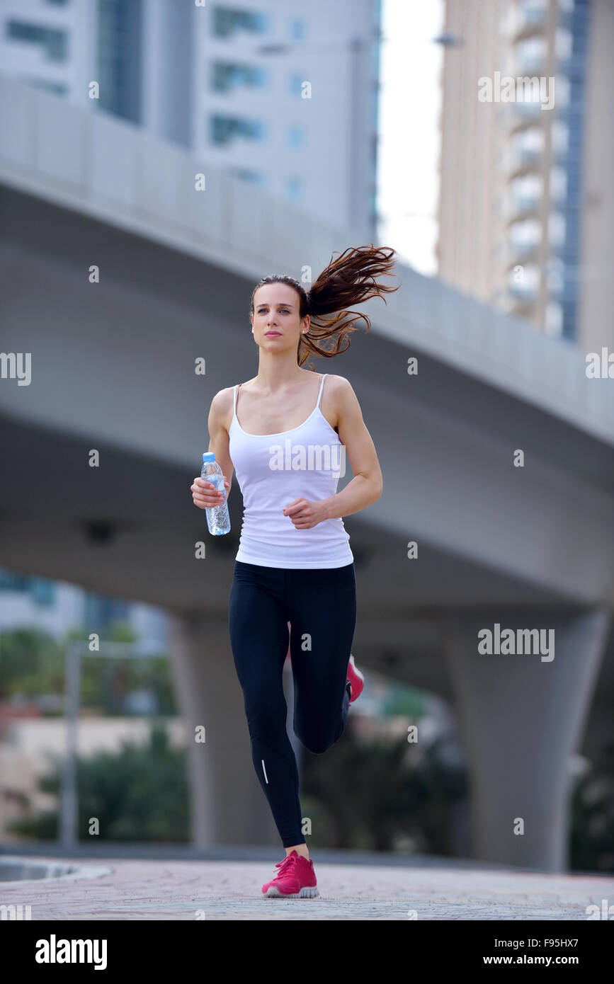 Running in city park. Woman runner outside jogging at morning with ...