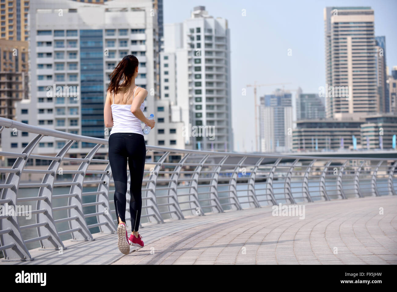 Running in city park. Woman runner outside jogging at morning with ...