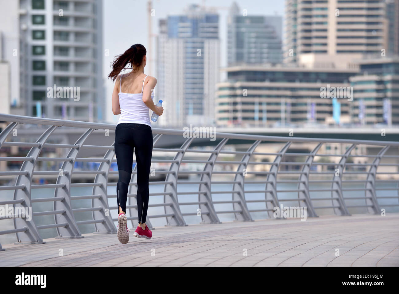 Running in city park. Woman runner outside jogging at morning with ...