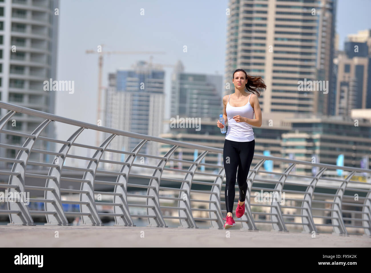 Running in city park. Woman runner outside jogging at morning with ...