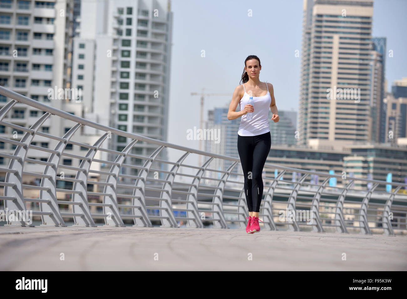 Running in city park. Woman runner outside jogging at morning with ...
