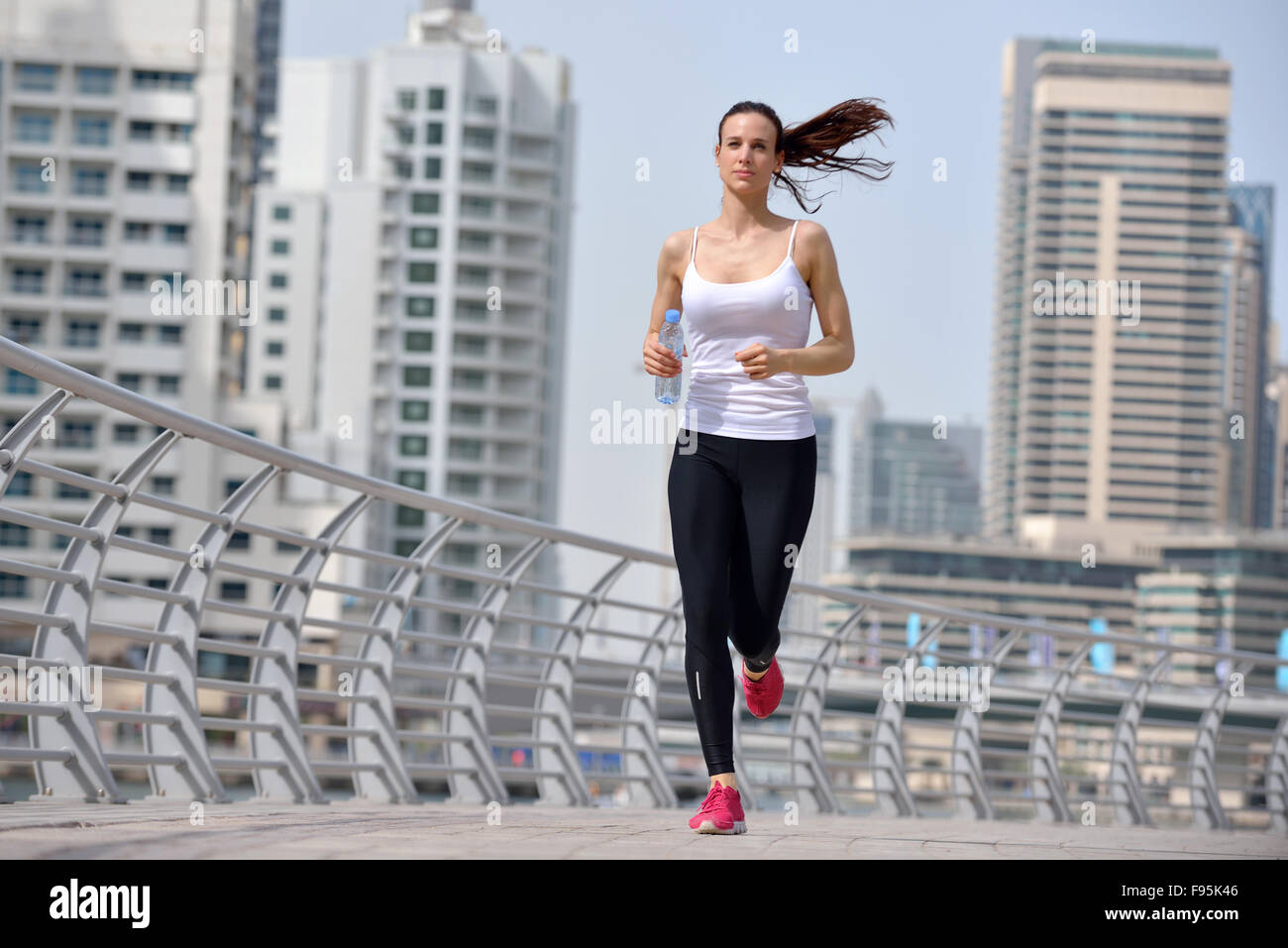 Running in city park. Woman runner outside jogging at morning with ...