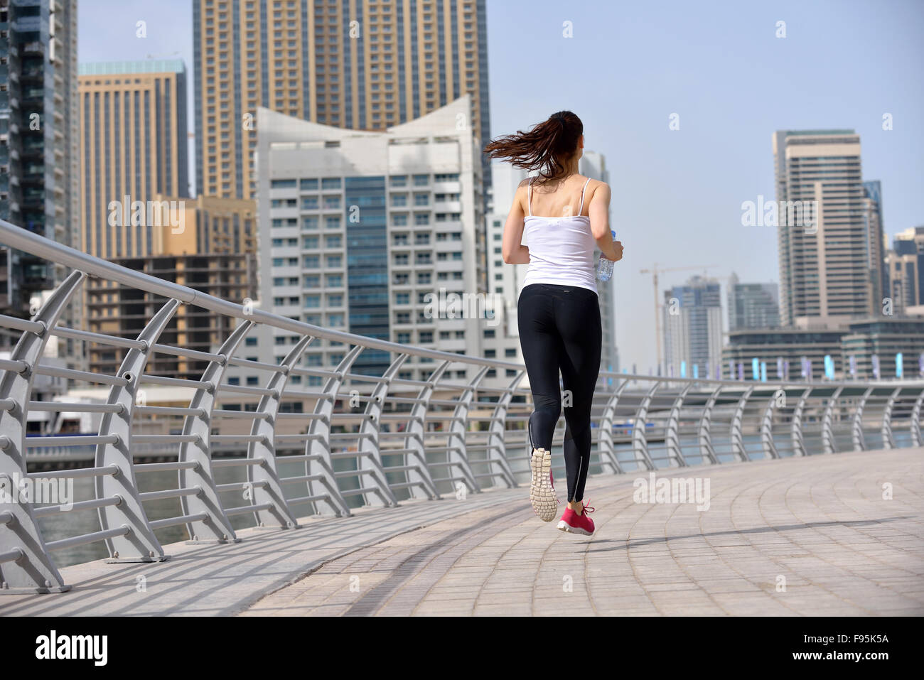 Running in city park. Woman runner outside jogging at morning with ...