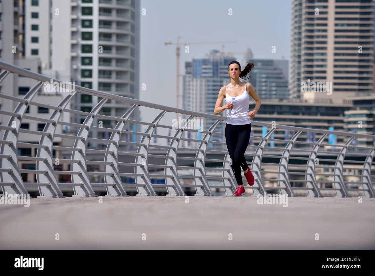 Running in city park. Woman runner outside jogging at morning with ...