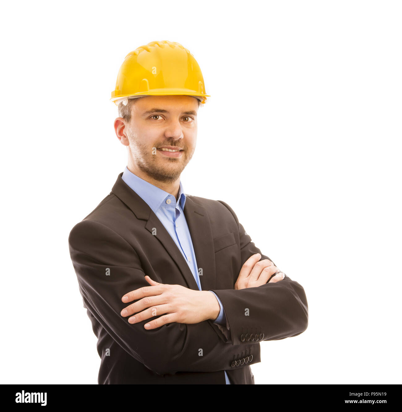 Young engineer with yellow helmet is isolated on white background Stock ...