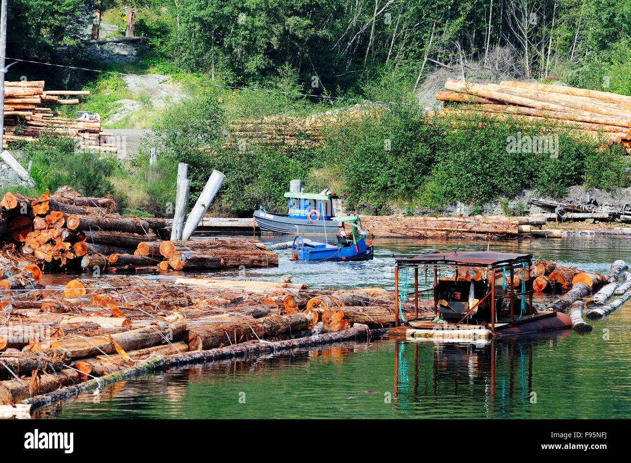 A dozer boat working around Western Forest Products log booms in Jordan ...