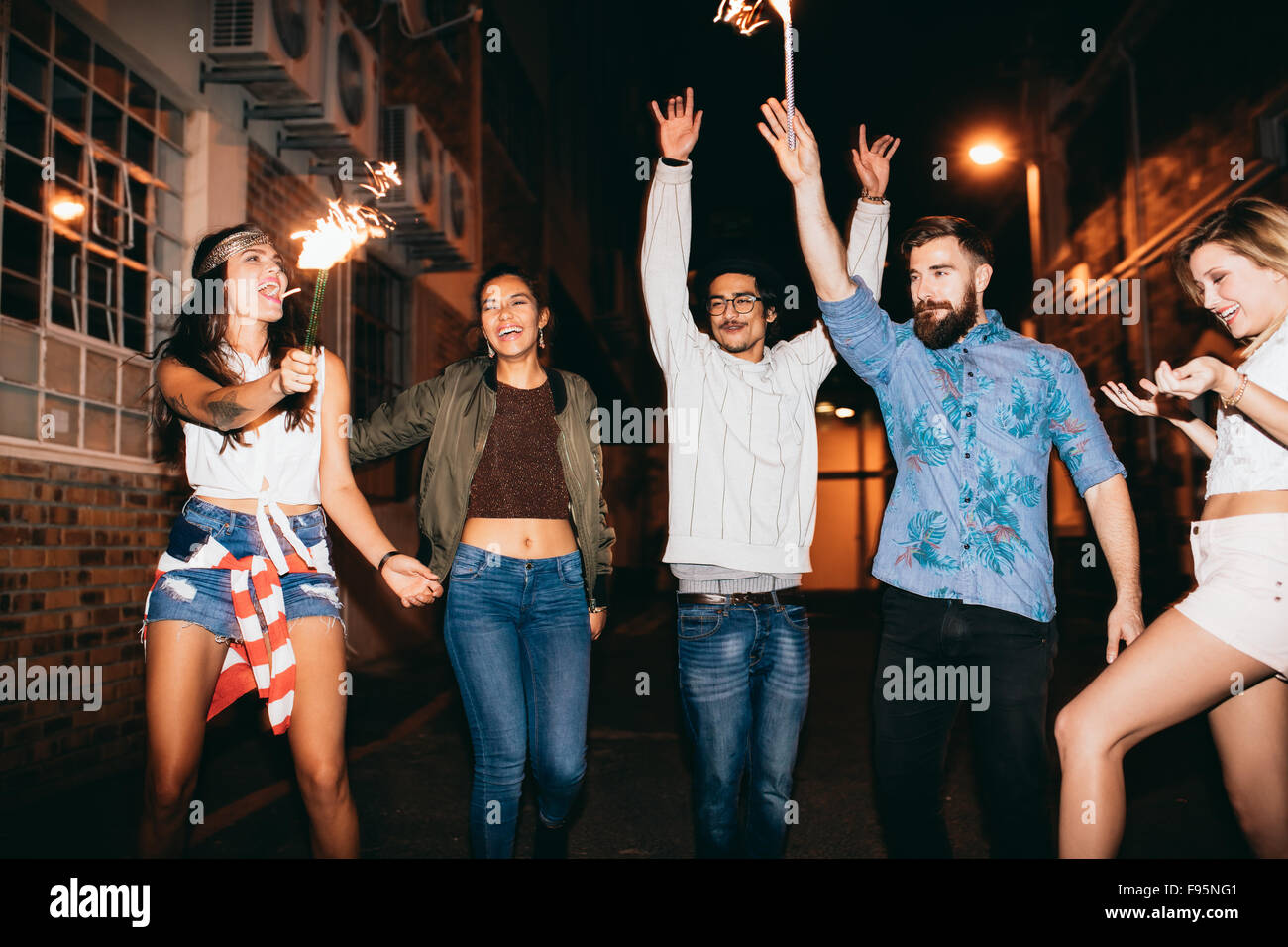 Portrait of happy young friends celebrating new years eve with ...