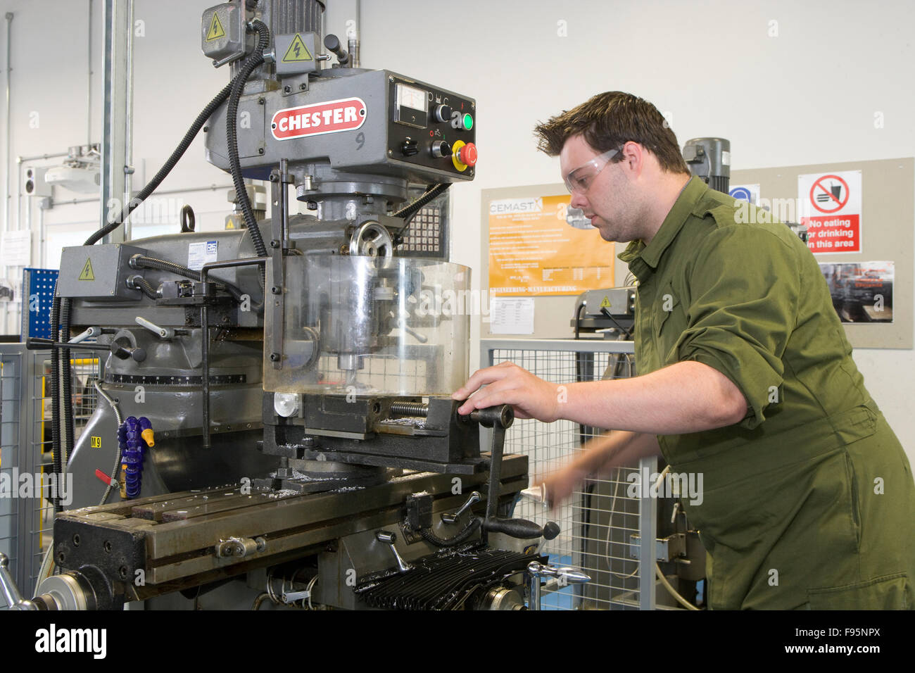 Apprentice operates milling machine / drill Stock Photo - Alamy