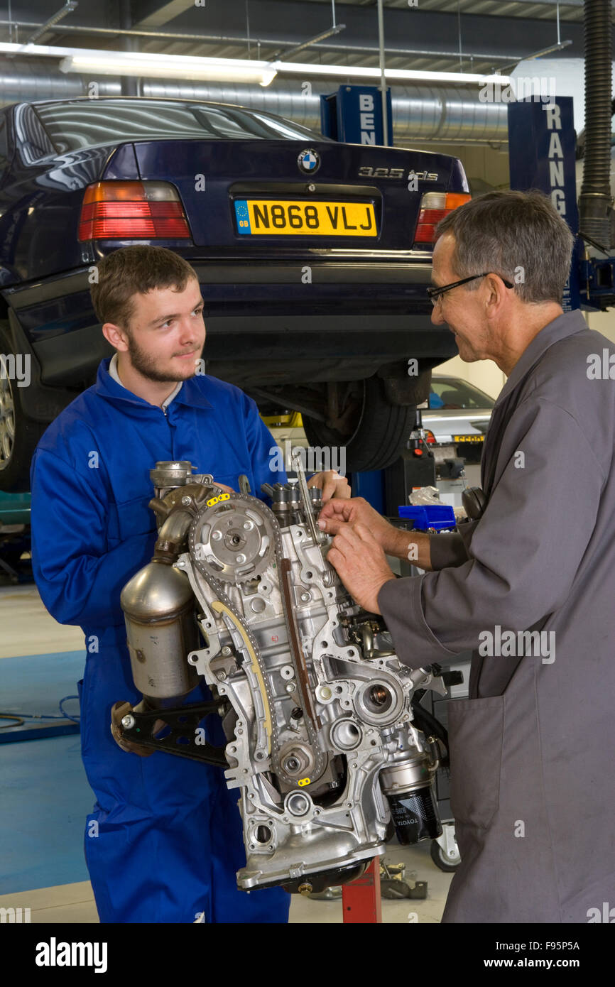 Apprentice car-mechanic & instructor Stock Photo - Alamy