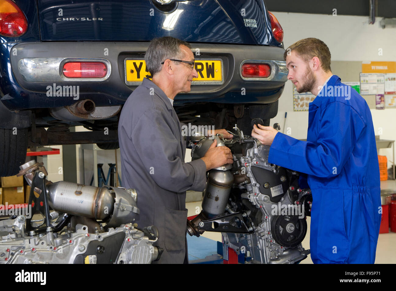 Apprentice car-mechanic & instructor Stock Photo - Alamy
