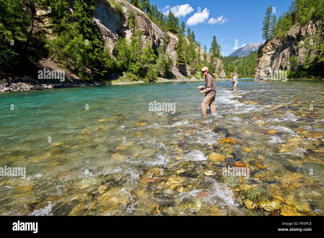 Two middleaged men flyfishing on Bull river, East Kootenays, BC, Canada ...
