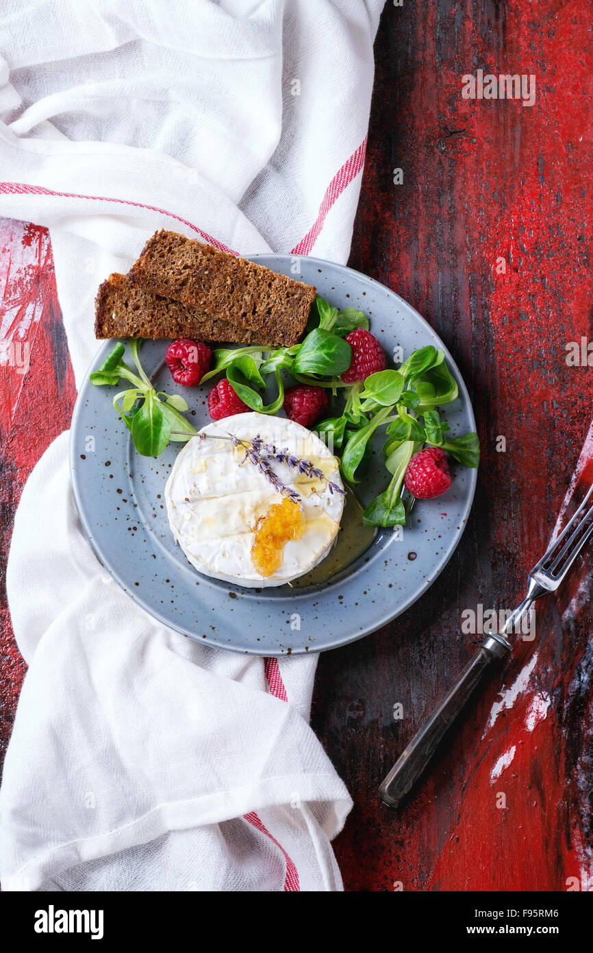 Goat cheese with honey and raspberries Stock Photo - Alamy