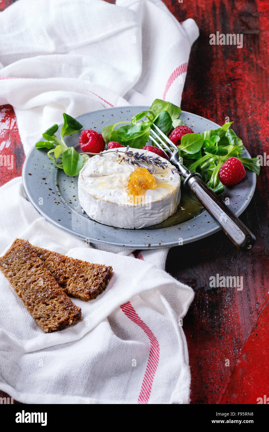 Goat cheese with honey and raspberries Stock Photo - Alamy