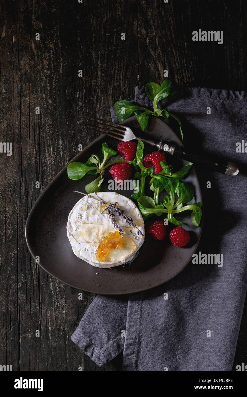 Goat cheese with honey and raspberries Stock Photo - Alamy
