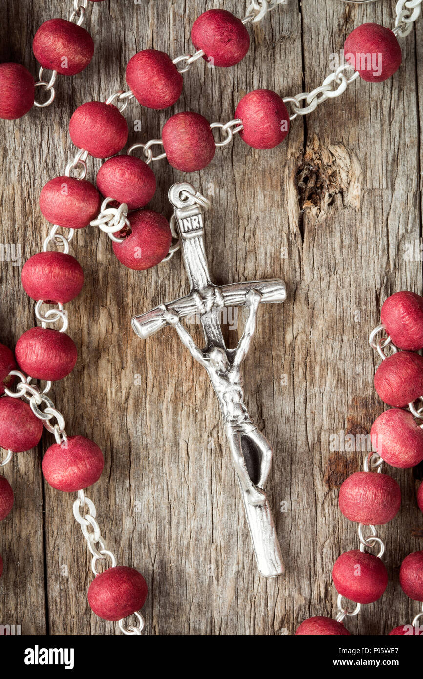 Catholic rosary on old wooden texture background Stock Photo - Alamy