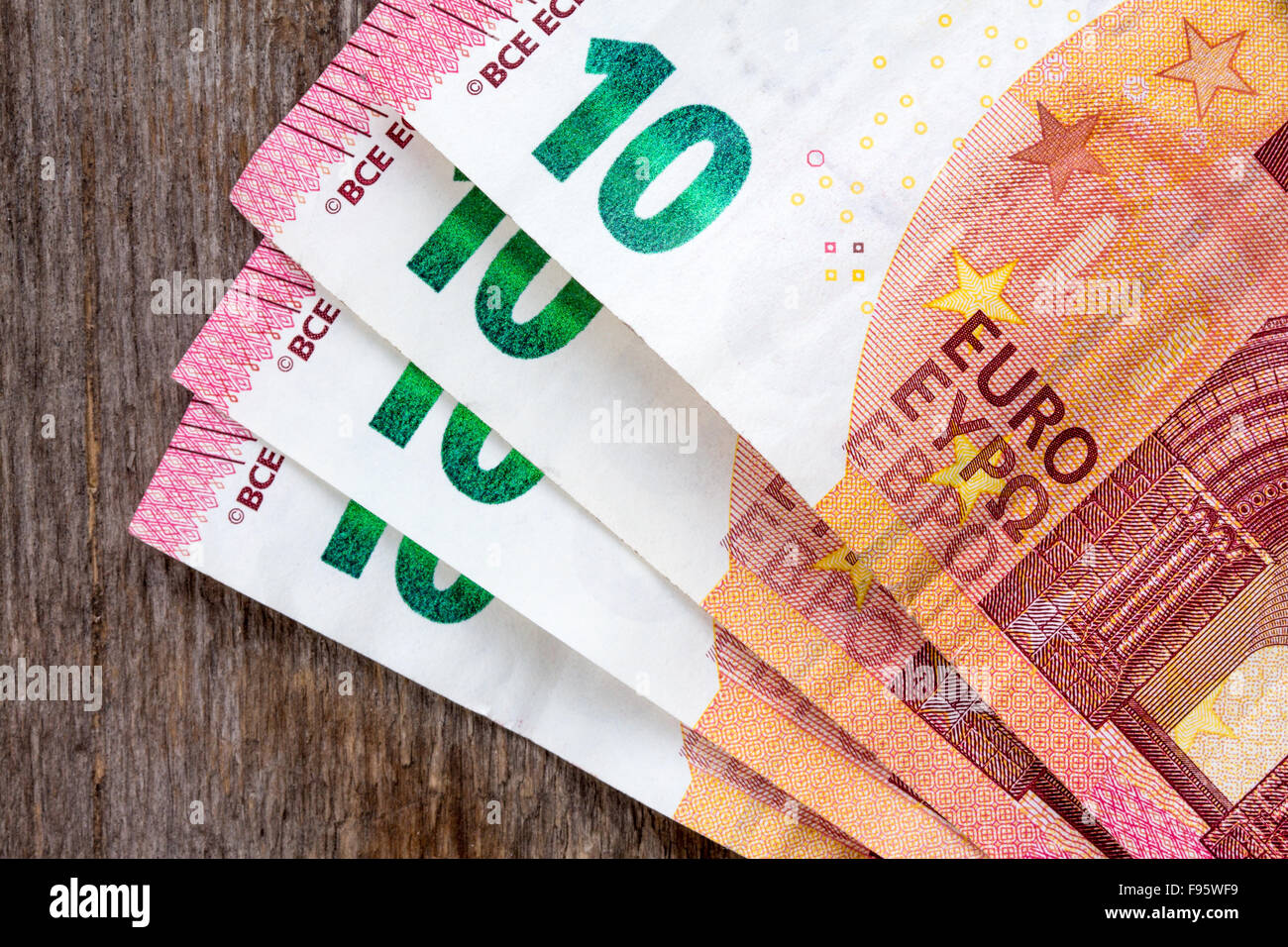 Ten euros notes laid on the wooden background Stock Photo - Alamy