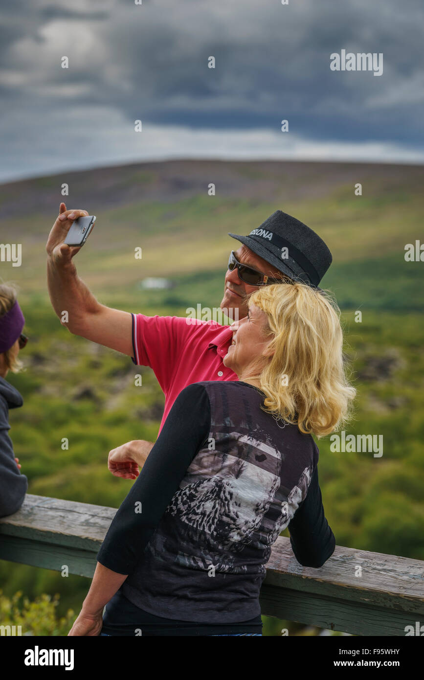 Tourists taking a selfie at Hraunfossar Waterfall, Iceland Stock Photo ...