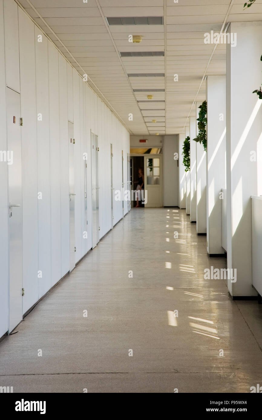 Very long corridor in business center with many offices Stock Photo - Alamy