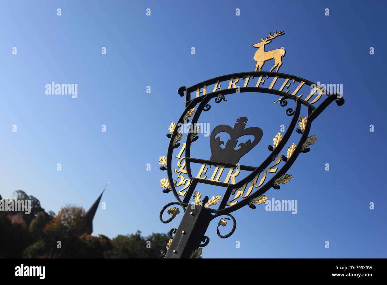 A sign in Hartfield Village overlooking the church steeple, based in ...