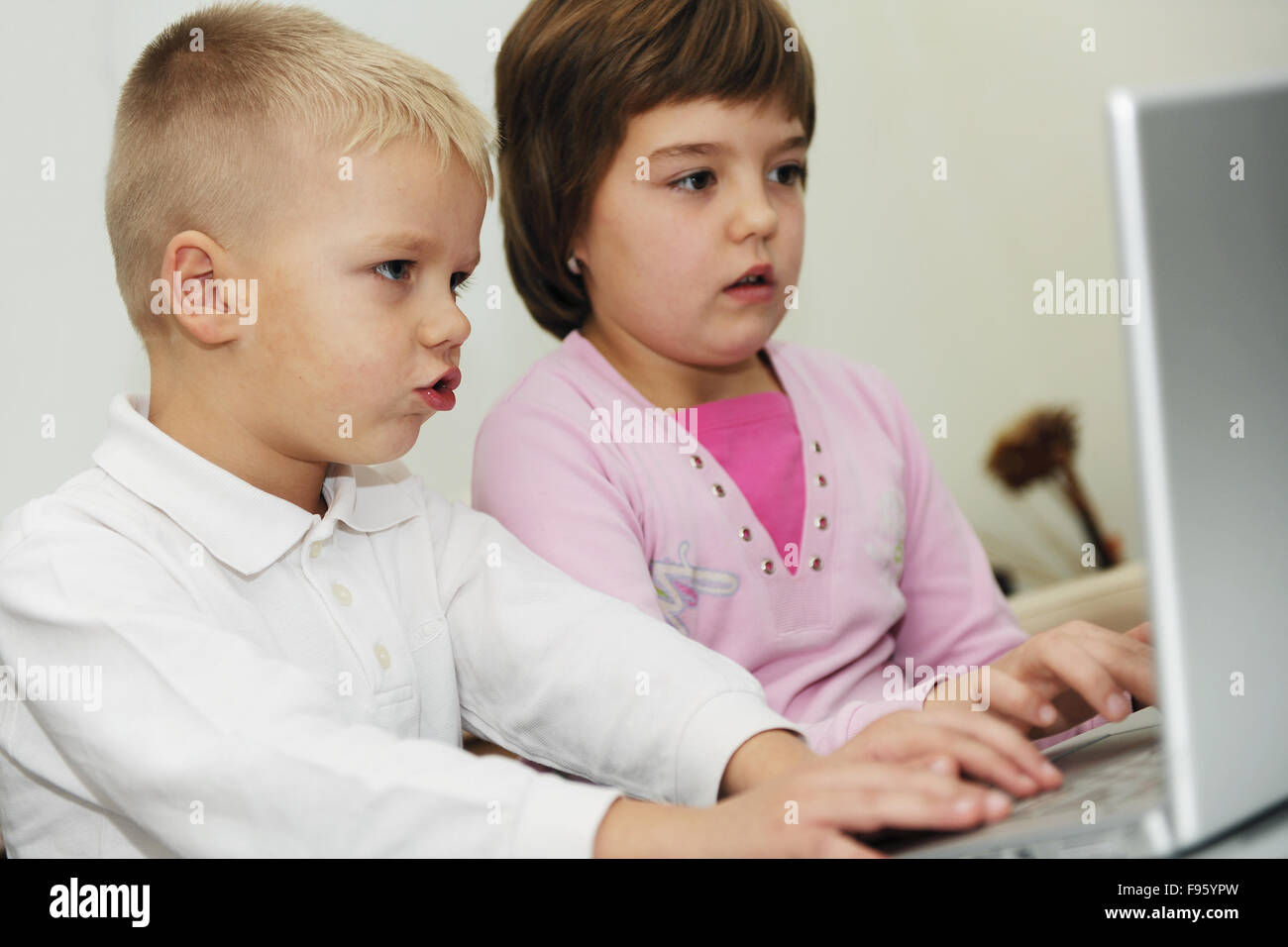 two happy children playing games and learnig education lessons on ...