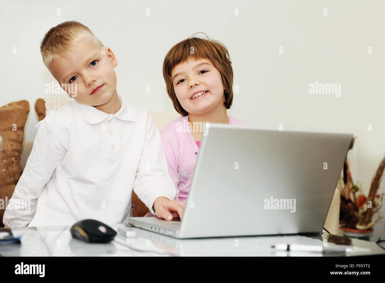 two happy children playing games and learnig education lessons on ...