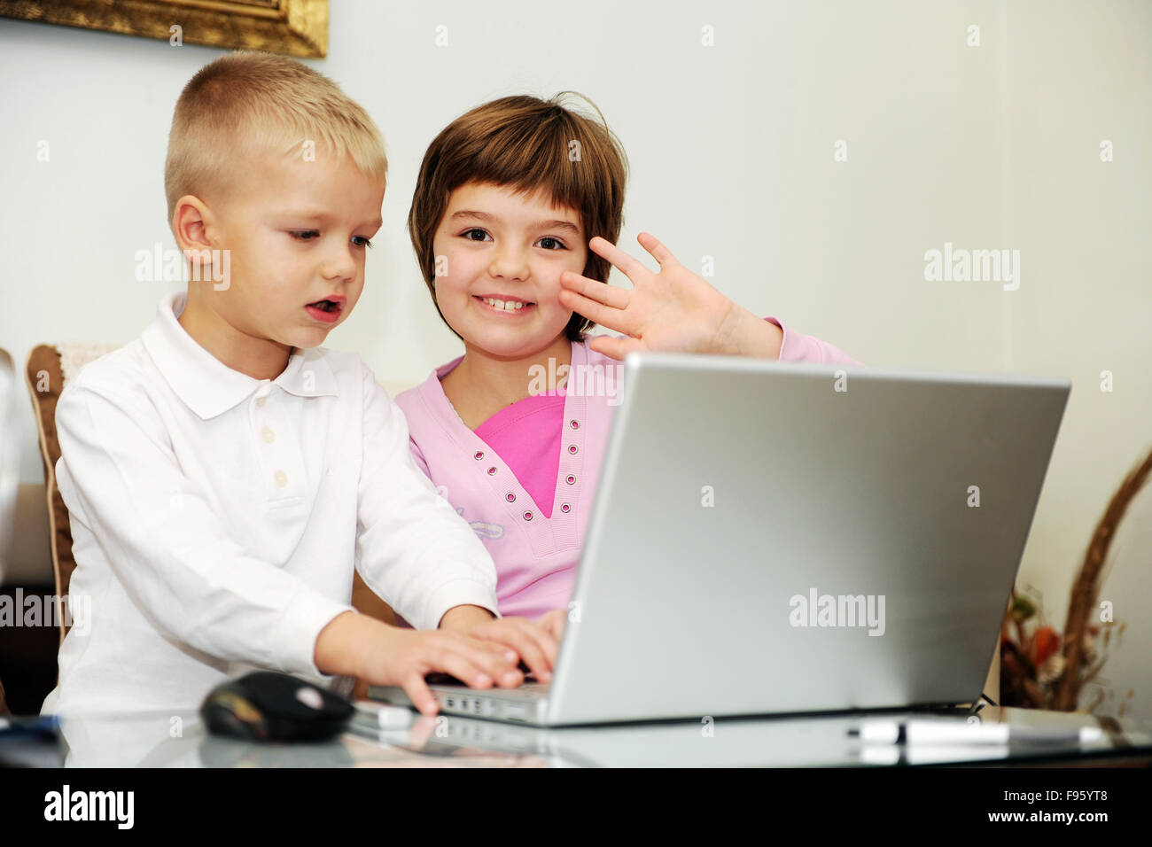 two happy children playing games and learnig education lessons on ...