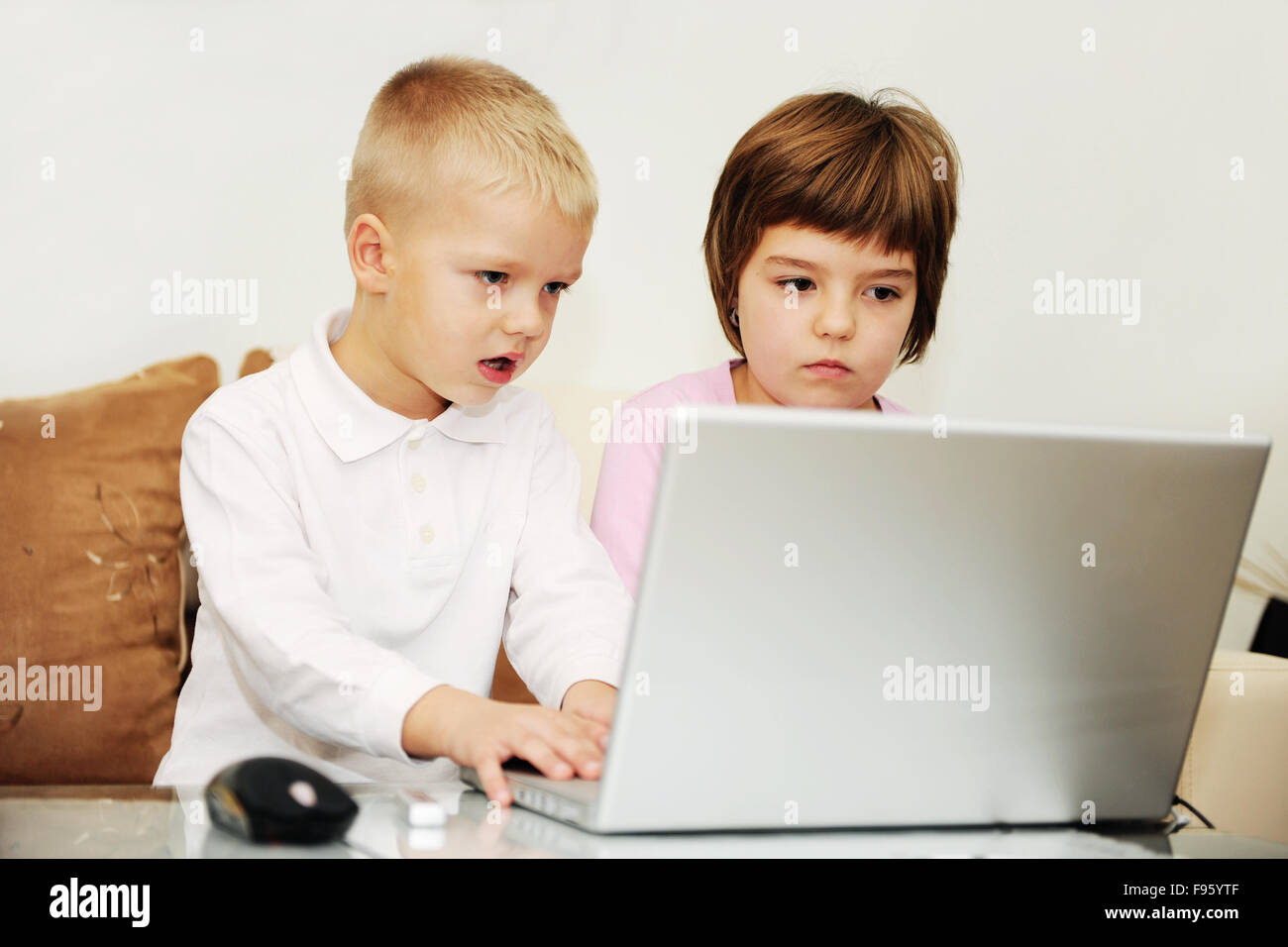 two happy children playing games and learnig education lessons on ...