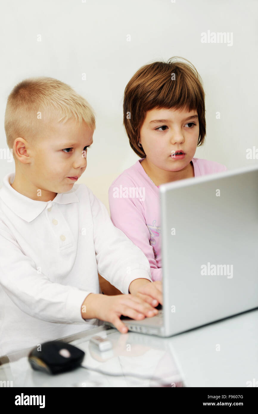 two happy children playing games and learnig education lessons on ...