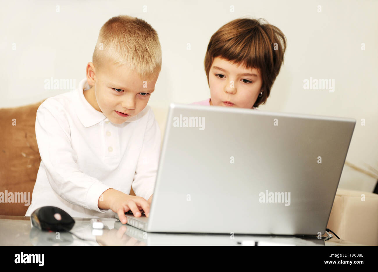 two happy children playing games and learnig education lessons on ...