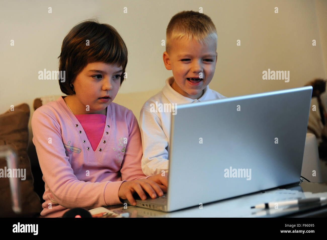 two happy children playing games and learnig education lessons on ...