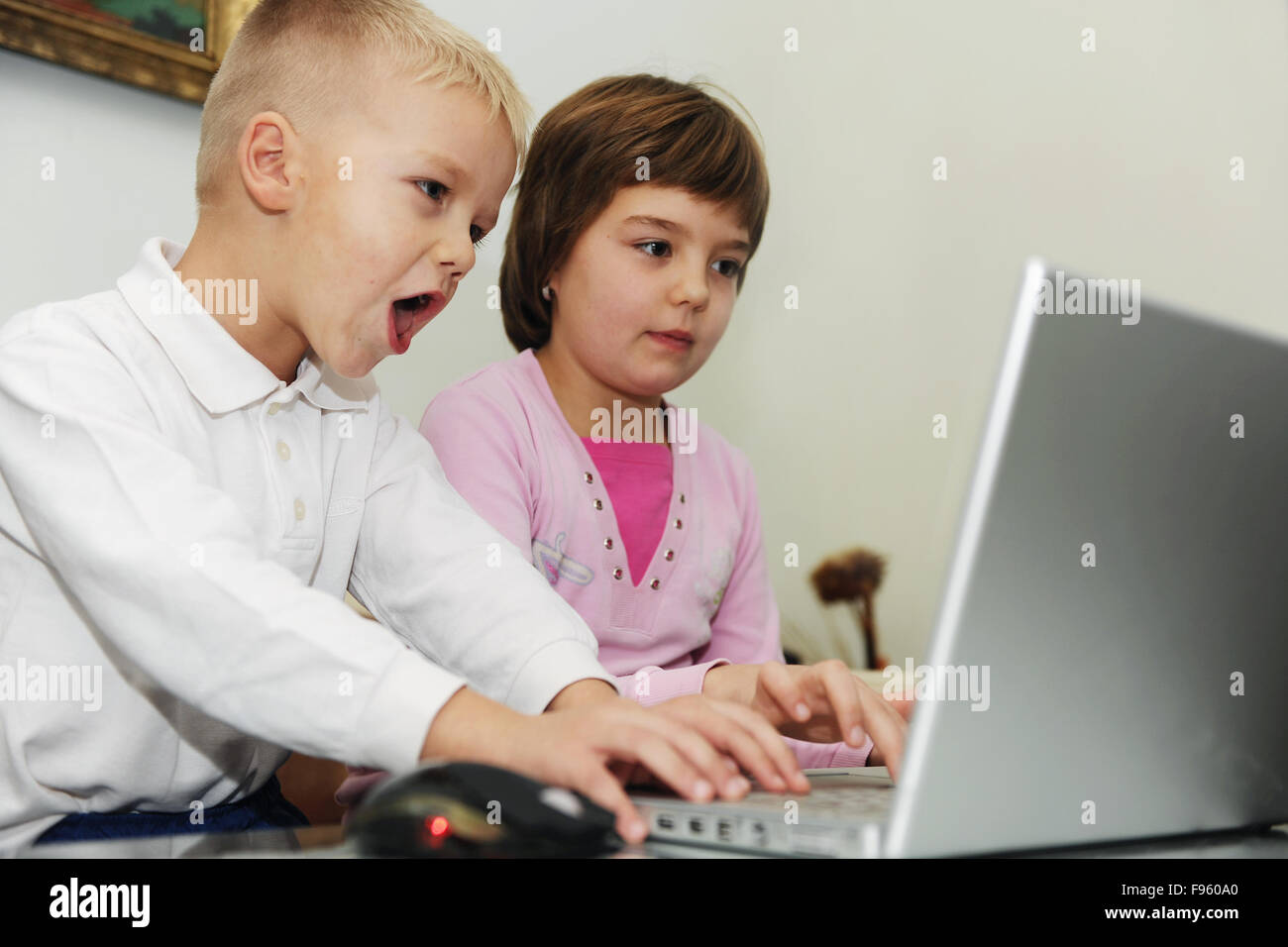 two happy children playing games and learnig education lessons on ...
