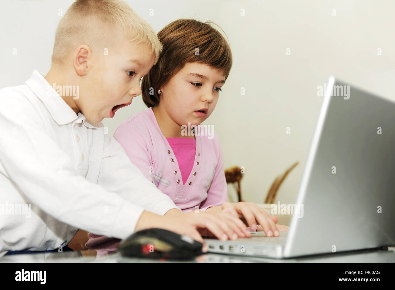 two happy children playing games and learnig education lessons on ...