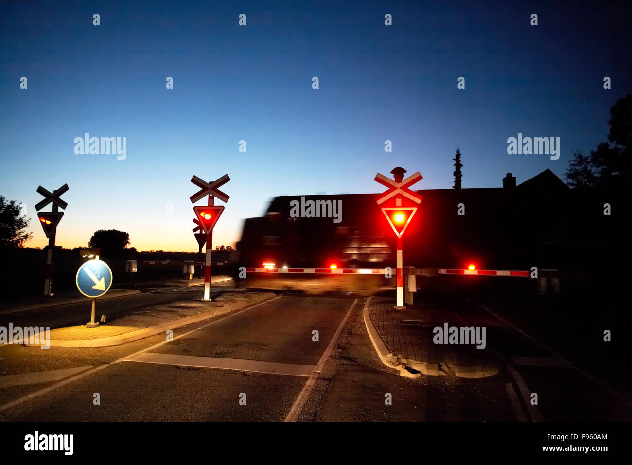 Train crossing at night Stock Photo - Alamy
