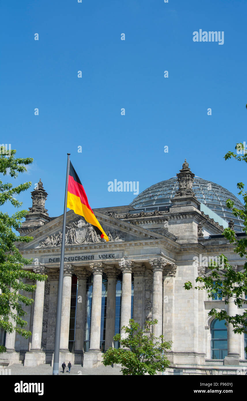 German flag and the Reichstag building, a historical edifice in Berlin ...