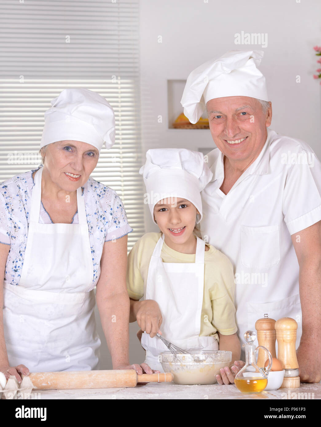 Happy family cooking together Stock Photo - Alamy