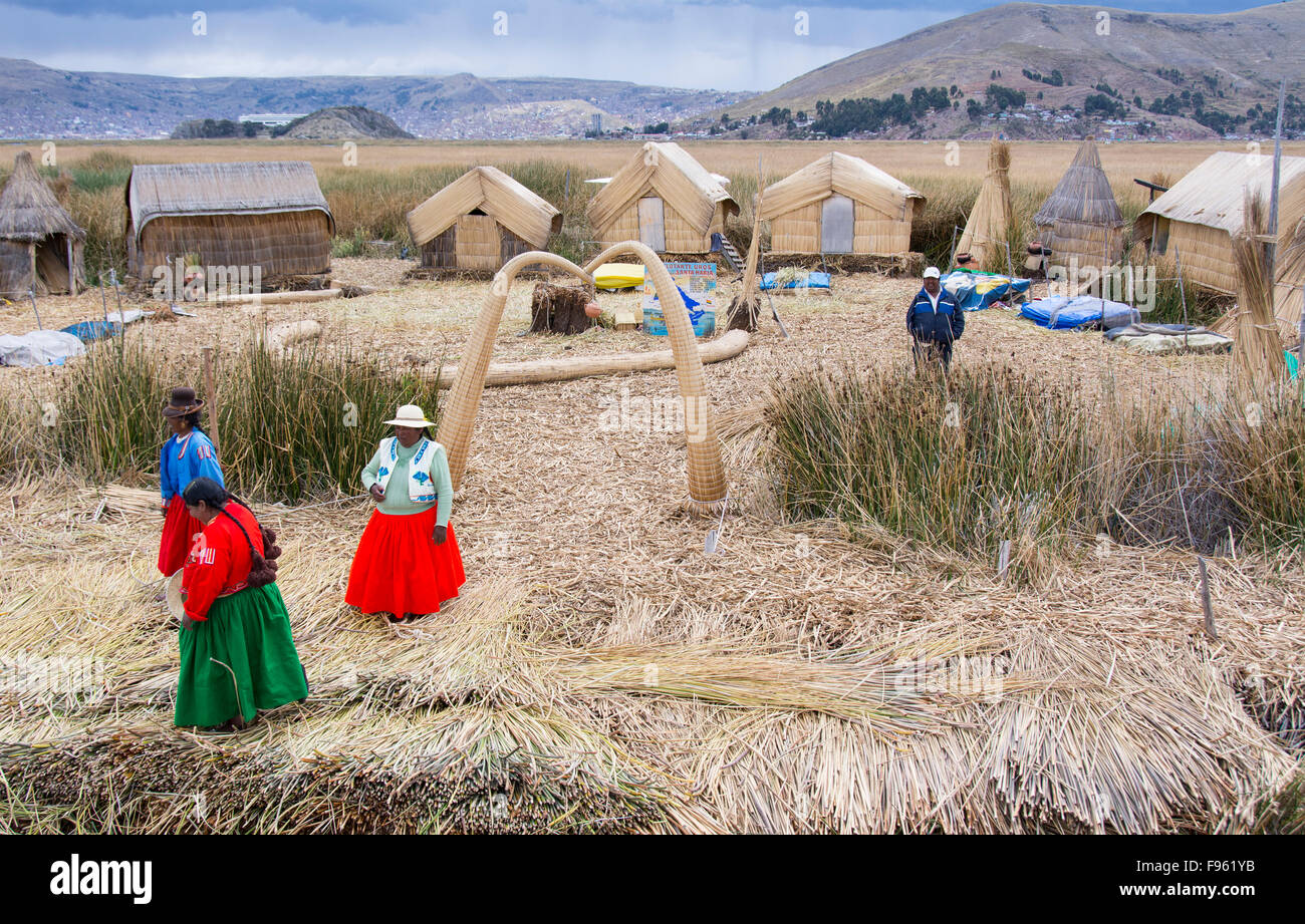 Local residents of floating reed islands of Uros, Lake Titicaca, Peru ...