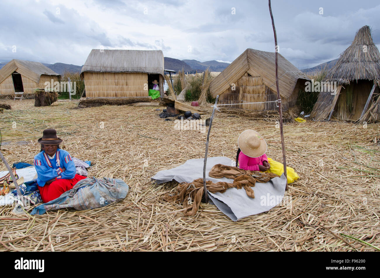 Local residents of floating reed islands of Uros, Lake Titicaca, Peru ...