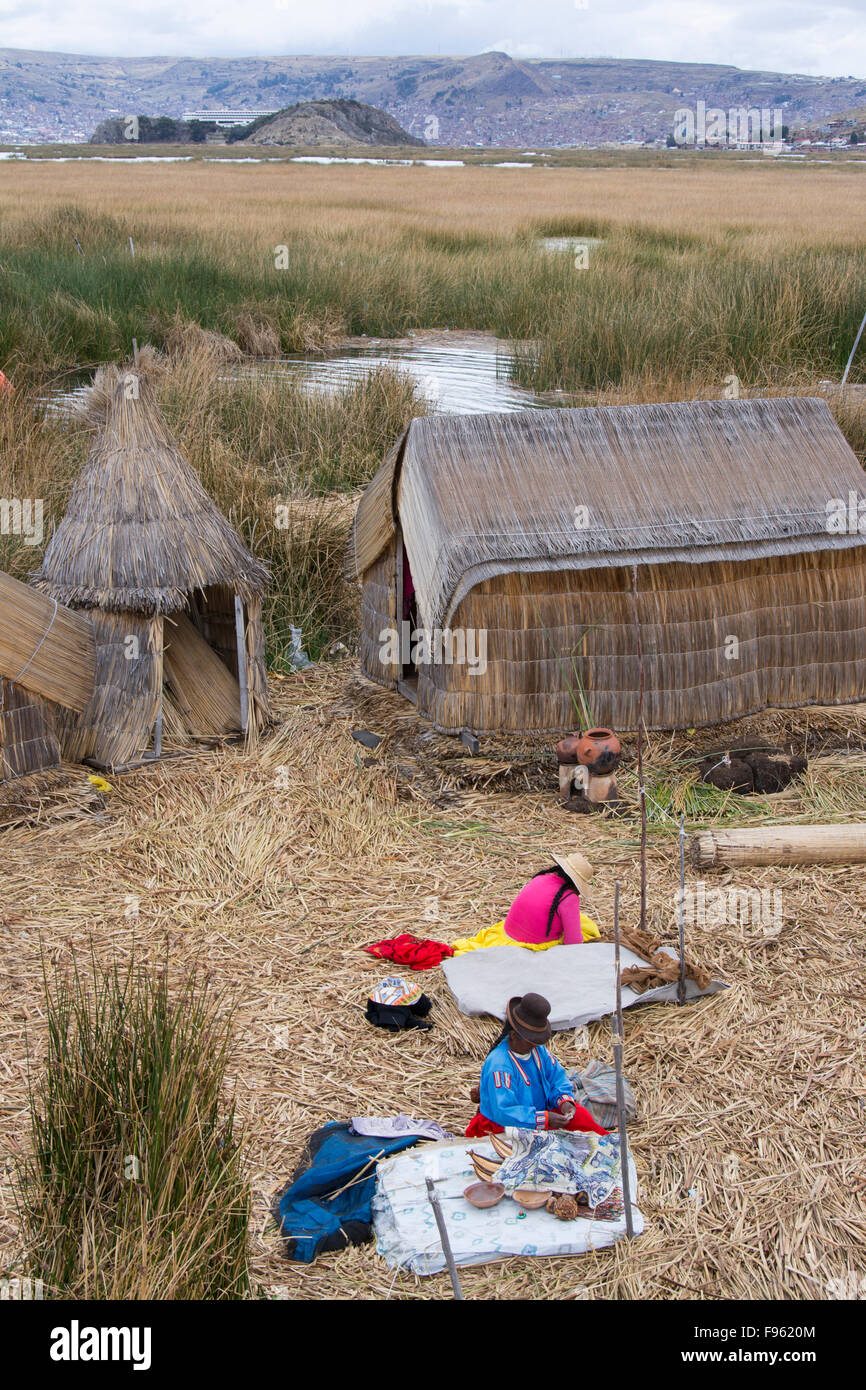 Local residents of floating reed islands of Uros, Lake Titicaca, Peru ...