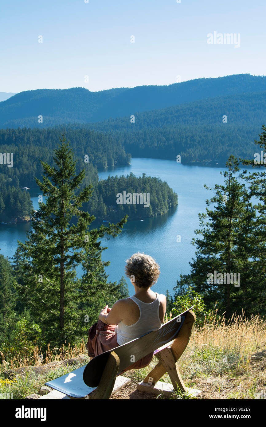 Elevated view of woman over Ruby Lake, Sunshine Coast, British Columbia ...