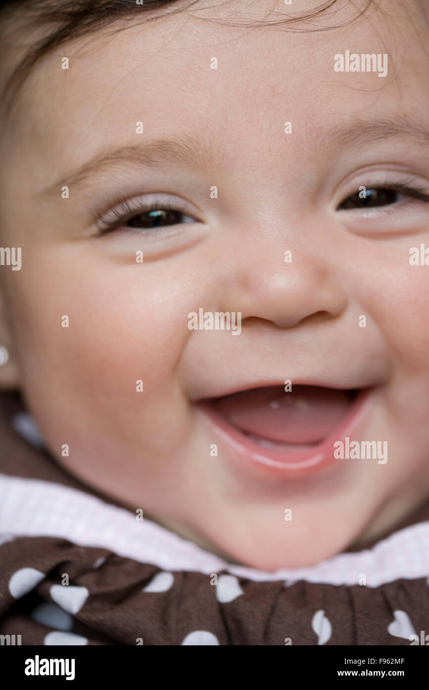 Portrait of a brown haired baby girl in her family's home in California ...
