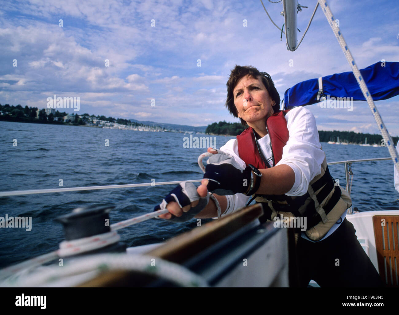 A woman hauls sails on a boat, Nanaimo, BC Stock Photo - Alamy
