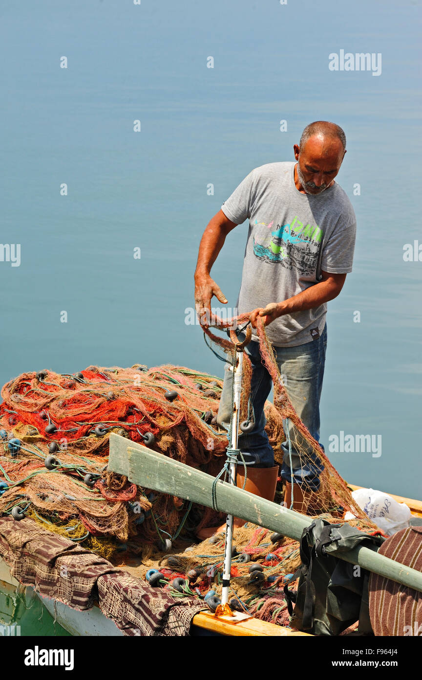 fisherman sorting his net, Ayvalik, Turkey Stock Photo - Alamy