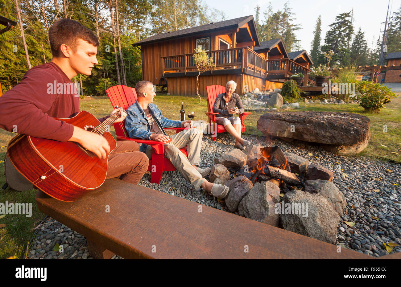 Friends gather around a fire while staying at the Ecoscape Cabins ...