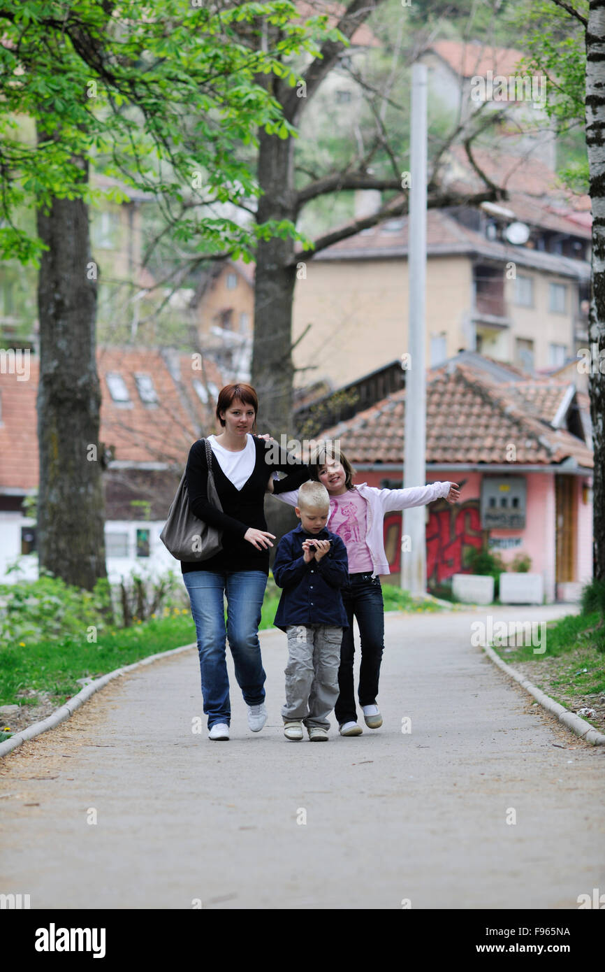 happy young family walking outdoor in park Stock Photo - Alamy
