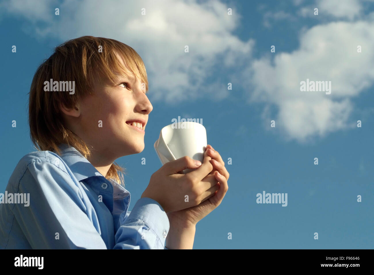 Happy little boy with cup Stock Photo - Alamy